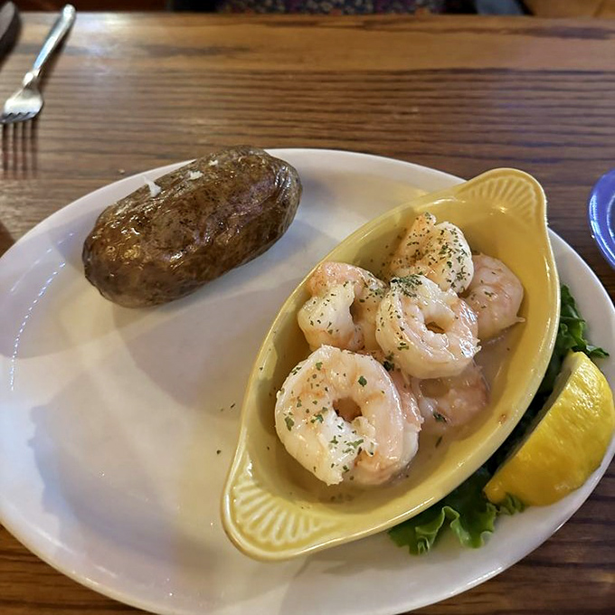These butterfly shrimp aren't just swimming in butter—they're doing the backstroke in flavor country. The lemon wedge is standing by for duty.
