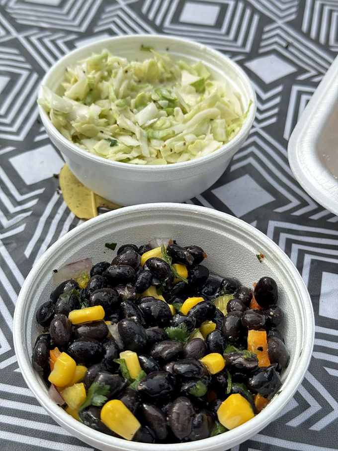 Fresh coleslaw and black bean salad—proof that sides aren't afterthoughts here but supporting actors deserving of their own standing ovation.