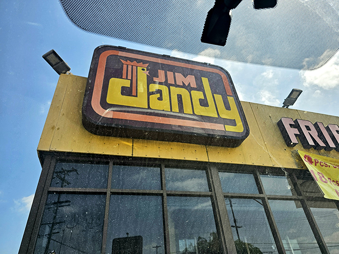 At night, that glowing Jim Dandy sign becomes a beacon of hope for the hungry, promising crispy salvation inside those humble walls.