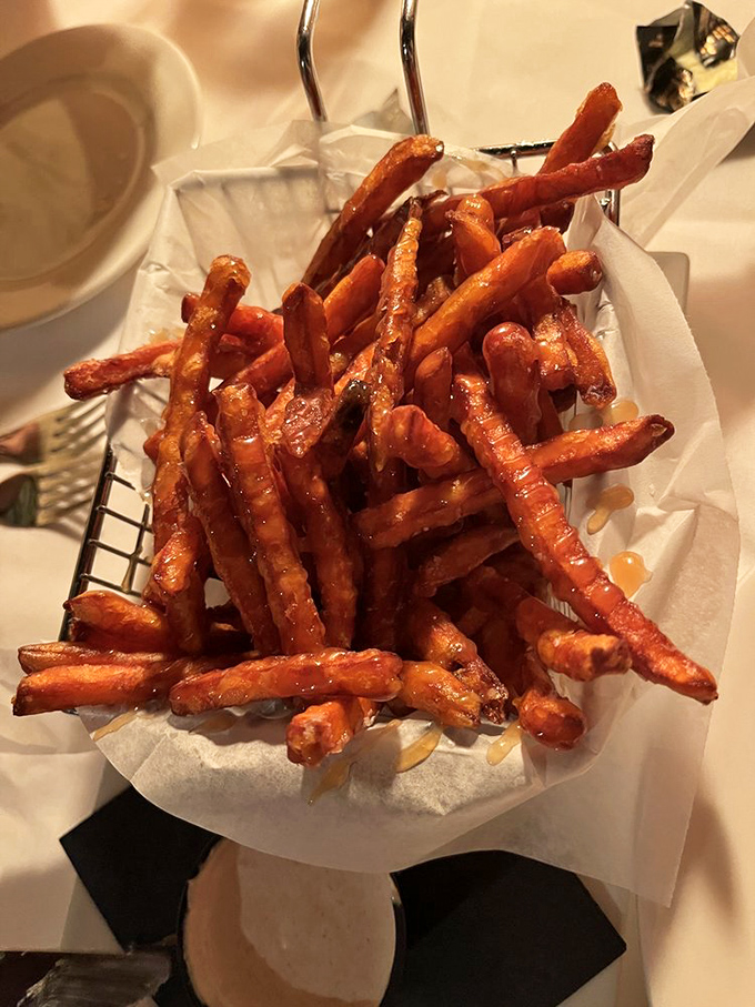 Sweet potato fries that have achieved the impossible trifecta: crispy exterior, soft interior, and enough seasoning to make you forget regular fries exist.