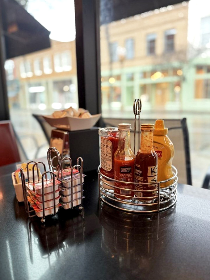The condiment caddy—civilization's greatest achievement. Hot sauce, syrup, and jam await your culinary decisions.