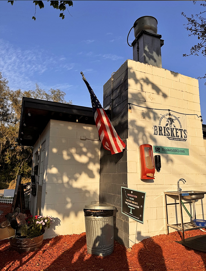 Even the exterior details show attention to craftsmanship—a simple outdoor sink and branded wall. In BBQ culture, functionality always trumps flash.