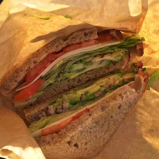 Layer upon layer of fresh vegetables, perfectly stacked between hearty bread – a sandwich that makes you forget meat exists.