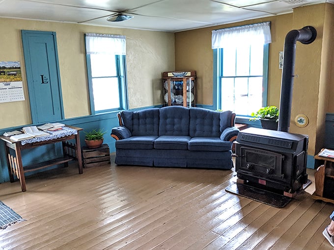 The living room's wood stove isn't vintage decor—it's still the functional heart of an Amish home where warmth comes from fire, not furnaces.