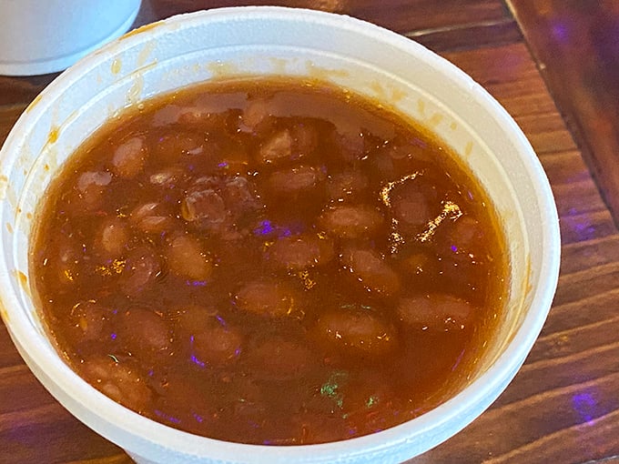 Baked beans swimming in a savory broth—the kind of side dish that threatens to upstage the main event with its humble, hearty appeal.