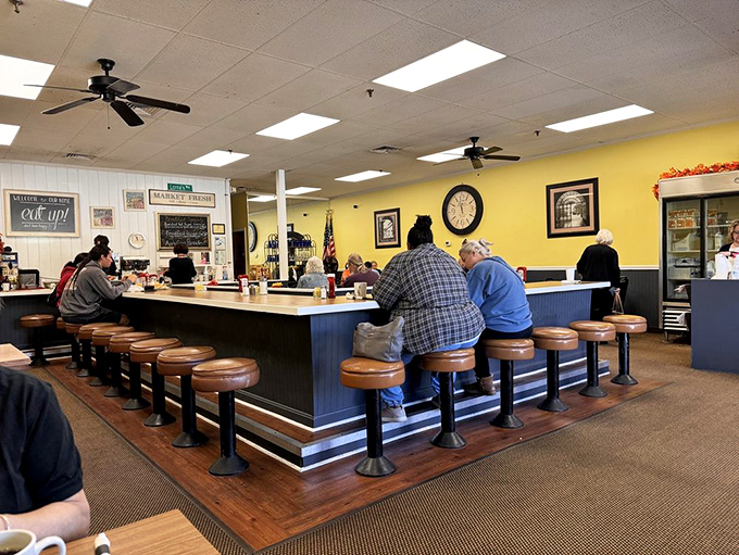 The counter where regulars claim their territory like friendly settlers, watching the morning unfold from their swiveling command posts.