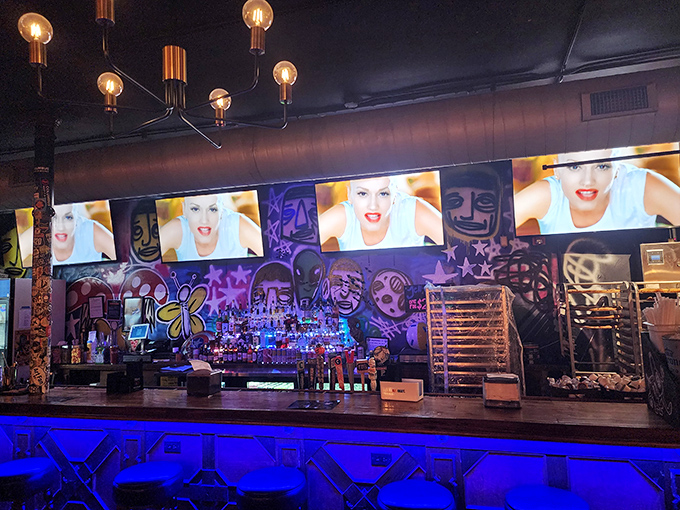 The bar area pops with neon blue light and street art vibes—a visual amuse-bouche before the main pizza event.