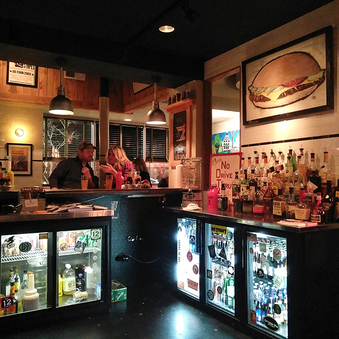 The bar isn't just where drinks are made—it's command central for Mercury's liquid happiness operations, complete with vintage burger artwork.