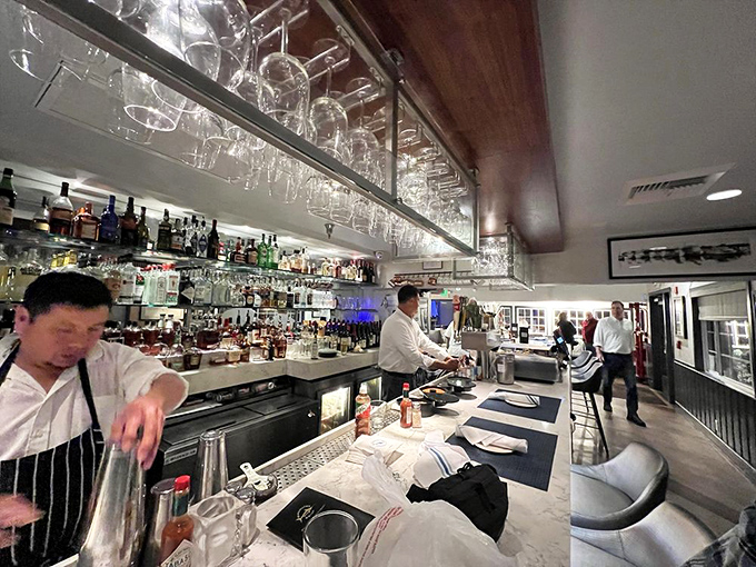 The bar—where mixology meets marine biology, and bartenders craft cocktails with the precision of seasoned sailors.