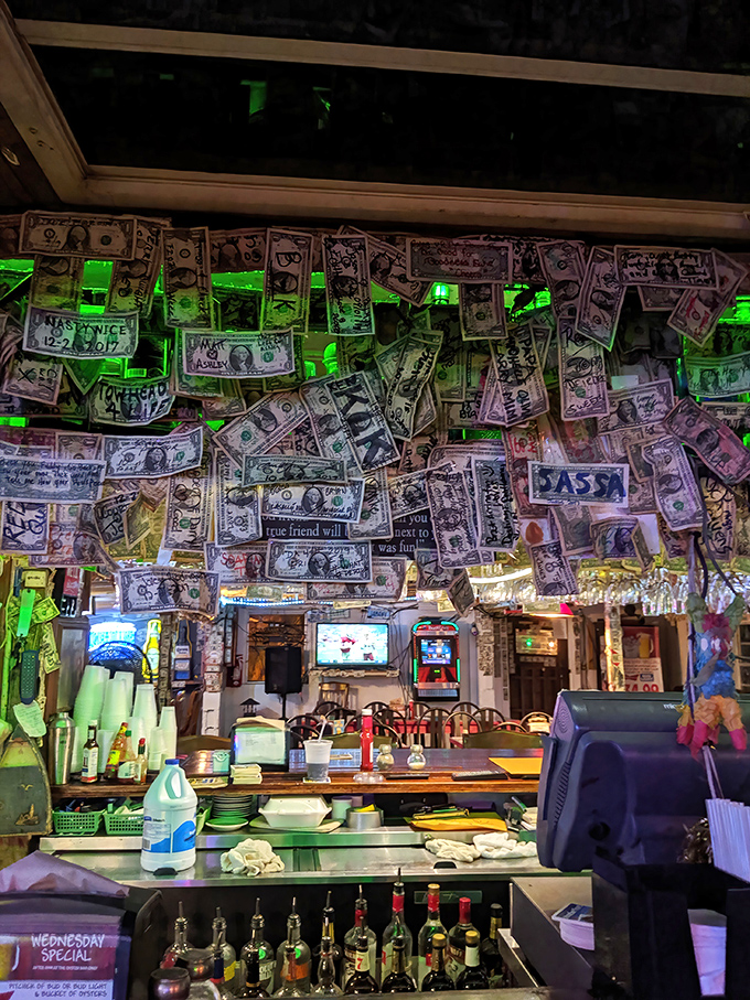 The bar area showcases decades of customer donations – dollar bills creating the world's most interactive wallpaper display.