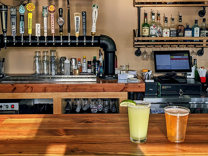 The bar—where craft beers flow and barbecue stories grow. Notice how everyone looks happier with each passing sip?