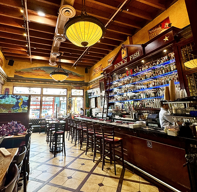 A bar stocked so thoroughly it looks like a liquid library, where the bartenders are both mixologists and storytellers.