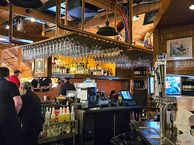 A bar that understands its mission: provide excellent drinks without unnecessary flourishes, while suspended glasses await their moment to shine.
