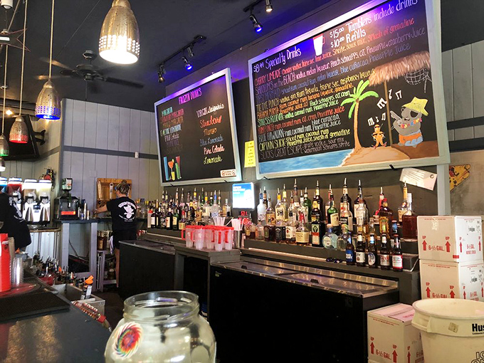 The colorful chalkboard menu behind the bar promises tropical concoctions that pair perfectly with fresh seafood and vacation vibes.