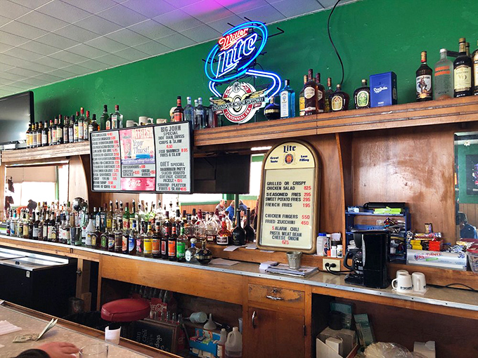 The bar area—where stories flow as freely as the drinks. That Miller Lite sign has witnessed decades of celebrations and consolations.