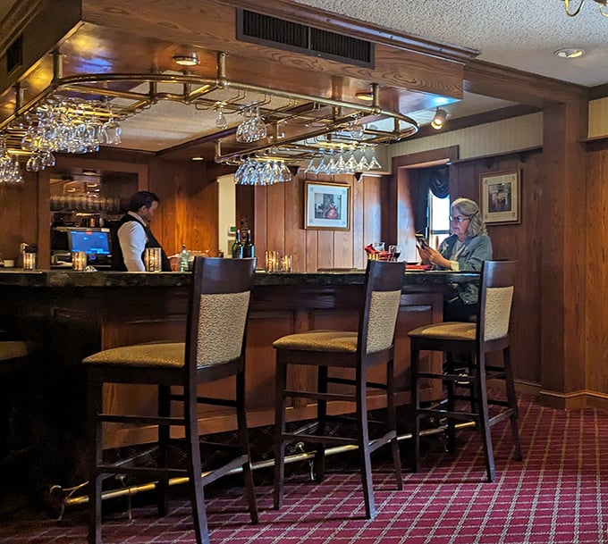 The bar area combines old-world woodwork with modern comfort, where classic cocktails are crafted with the reverence they deserve.