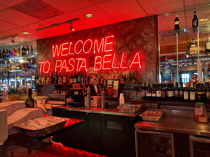 The neon "WELCOME TO PASTA BELLA" sign – hospitality in electric form. This bar area practically guarantees a good time is about to unfold.