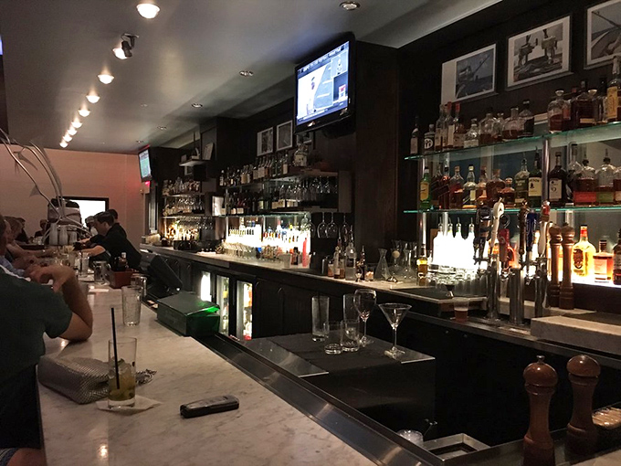 A bar stocked for serious cocktail crafting. The bottles gleam like treasure, promising libations worthy of your special occasion – or just Tuesday.