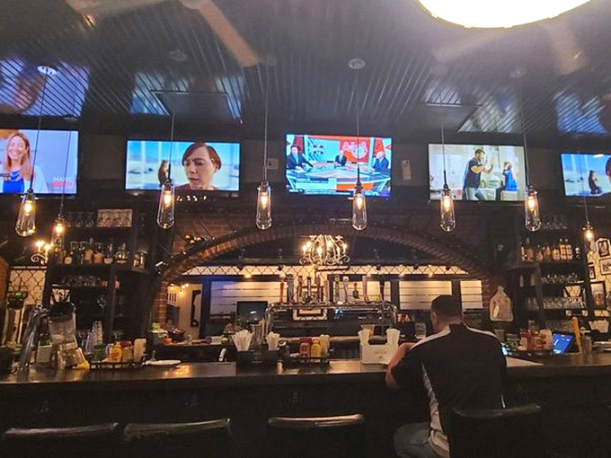 The bar area combines sports bar energy with deli authenticity. Those pendant lights aren't just illuminating the space—they're spotlighting potential happiness.