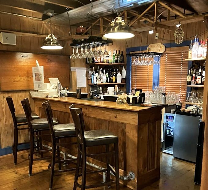 The bar area—where nautical dreams and craft cocktails come together. Those hanging glasses are just waiting to be filled with something wonderful.