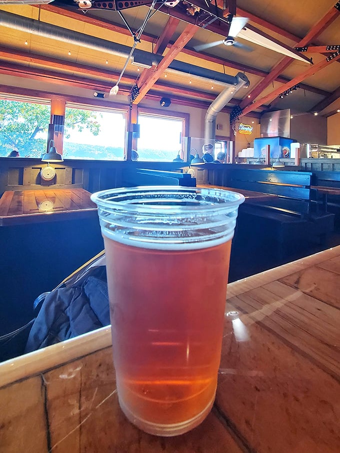 A cold one with a view—this amber brew sits proudly against the backdrop of Skeeter's rustic interior, ready to tame the fire of barbecue spice.