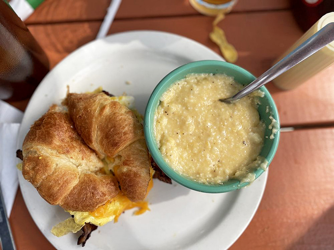 A breakfast sandwich and grits served in that turquoise bowl – Southern comfort that doesn't need to shout about its credentials.