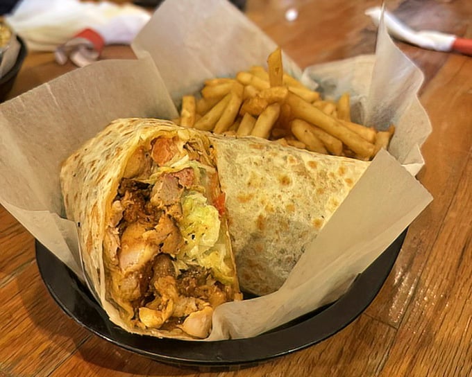 This wrap isn't just holding meat—it's cradling dreams. With those golden fries alongside, it's a portable feast worthy of celebration.