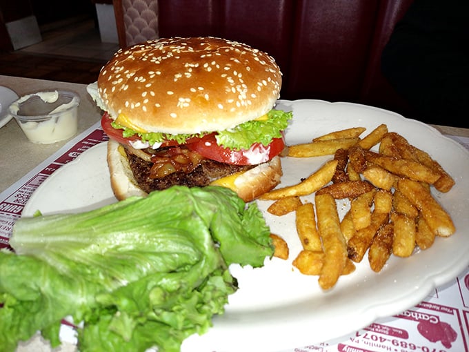 A classic diner burger with all the fixings and a golden pile of fries. Some food traditions don't need reinvention—just proper execution.
