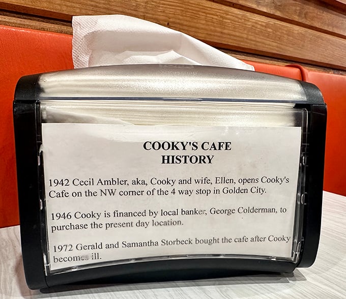 Every great restaurant has a story—Cooky's history napkin holder reveals the cafe's journey since 1942, when a slice of pie cost less than your morning coffee today.