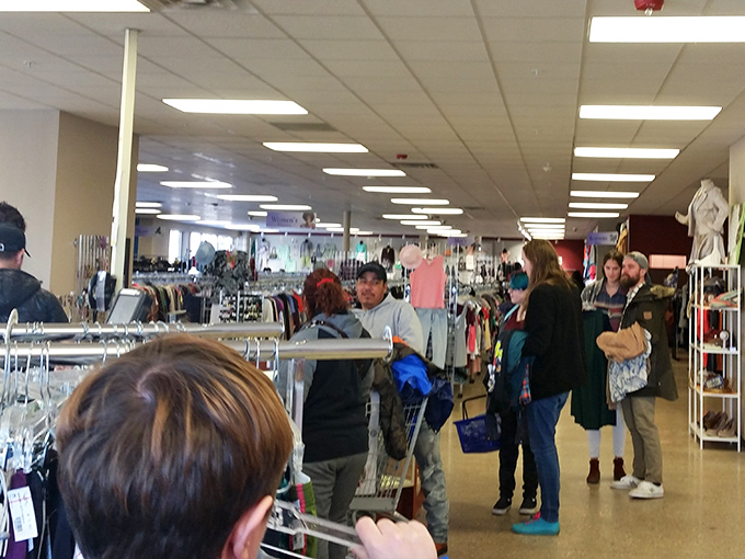 The thrifting journey's final chapter—where shoppers gather with their discoveries, each cart telling a different treasure-hunting tale.