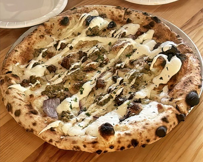 When mushrooms and cheese unite on a perfectly charred crust, it's not just dinner—it's a religious experience.