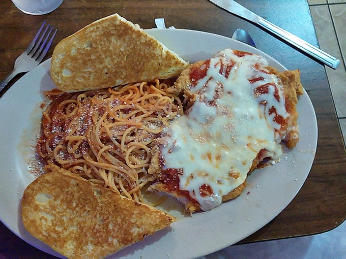 When spaghetti meets garlic toast and melted cheese, it's not just Italian-American cuisine—it's a beautiful carb collaboration that works.