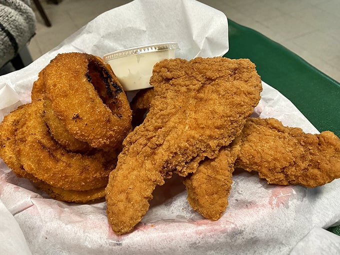 Golden-fried chicken tenders and onion rings – proof that sometimes the simplest pleasures are the most satisfying, especially when the breading is this perfect.