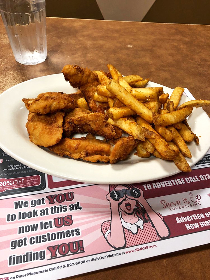Golden chicken tenders and fries – comfort food that transcends age, making adults feel like kids and kids feel like they've hit the jackpot.