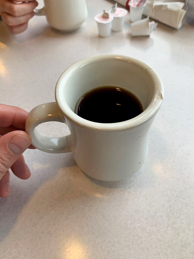 The diner coffee mug—small but mighty, ready to transform morning zombies into functioning humans one sip at a time.