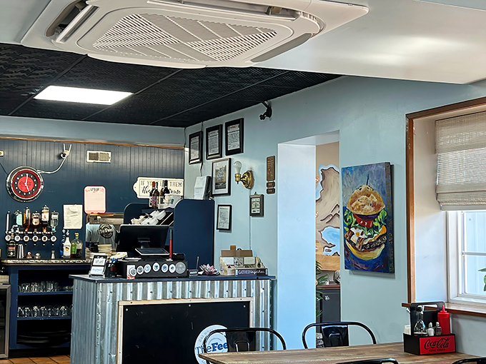 Behind this counter, culinary magic happens. The burger artwork watches over proceedings like a patron saint of good eating.