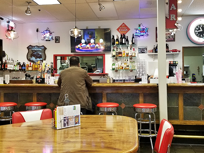 The counter where magic happens. Those red stools have witnessed countless first dates, family celebrations, and travelers finding their new favorite diner.