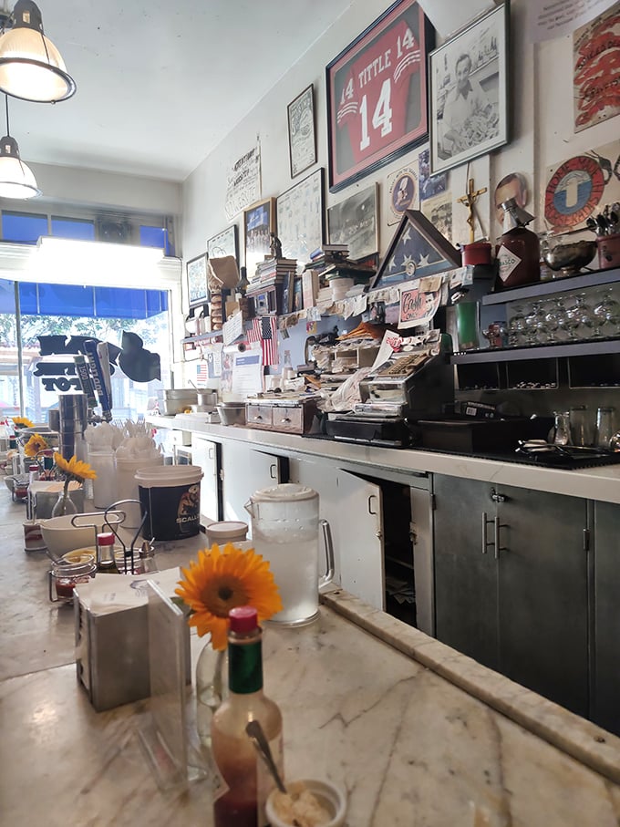 The counter view – where maritime memorabilia meets culinary magic. Every framed photo and knickknack tells part of Swan's storied history.