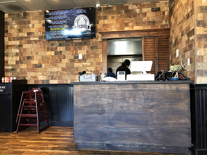 Where burger magic happens. That simple wooden counter separates hungry mortals from kitchen wizards performing feats of culinary alchemy.