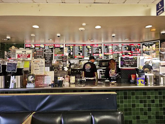 Behind this counter, culinary magic happens with practiced efficiency—where orders are called out in a shorthand language developed over decades.