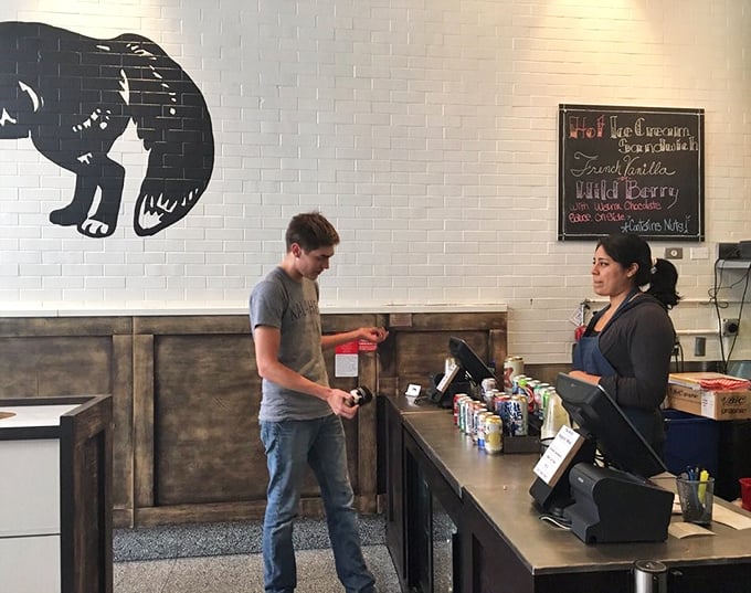 The silhouette of a bear watches over transactions at the counter—a fitting spirit animal for a place that understands comfort food is serious business.