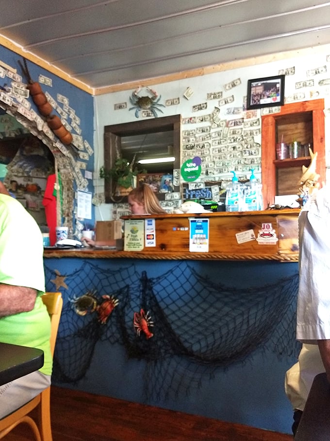 The heart of operations where seafood dreams become reality. That blue wall with fishing nets sets the perfect coastal mood.
