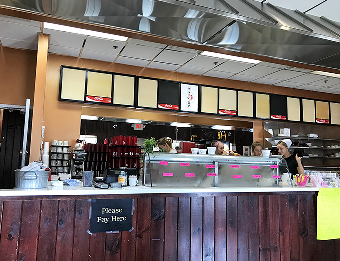 The heart of operations—where orders are called, coffee is poured, and the magic happens. No pretension, just efficiency with a side of friendliness.