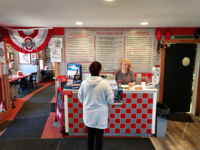 The checkerboard counter welcomes you like an old friend. Behind it, the full menu looms like a challenge: "Think you can try everything?"