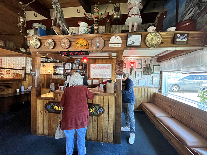 The host station isn't just where you wait—it's the gateway to pancake paradise, guarded by Alpine treasures and friendly faces.