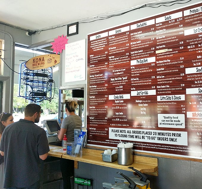 Behind this counter, burger alchemy happens daily—where ordinary ingredients transform into extraordinary memories under the watchful eye of a Giants pennant.