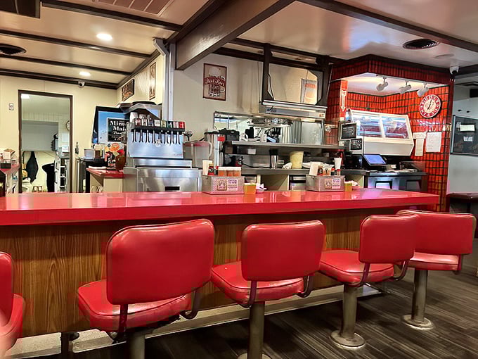 The counter seats offer front-row tickets to the culinary show, where red vinyl stools have supported generations of hungry patrons awaiting barbecue bliss.