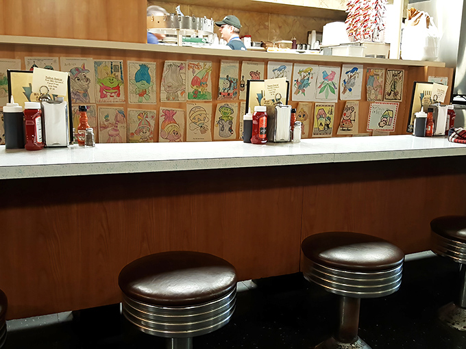 The counter seats—where solo diners become regulars and servers remember your order before you've even settled onto the chrome stool.