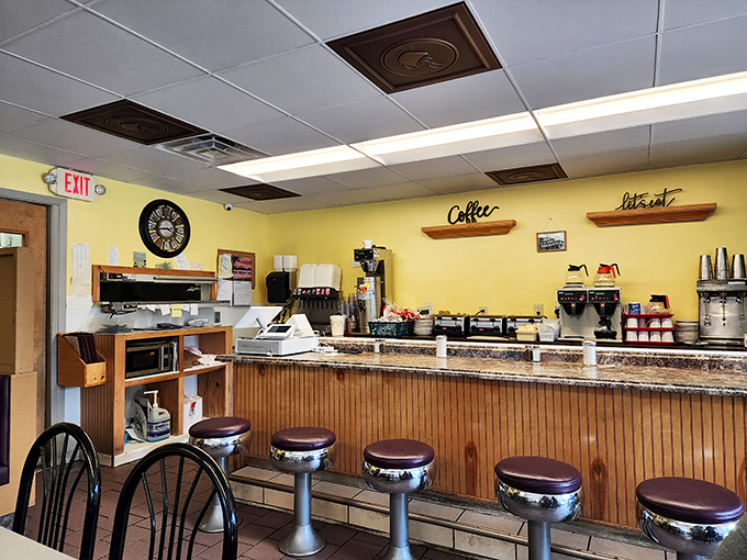 The counter seating – where solo diners become regulars and regulars become family, one cup of coffee at a time.