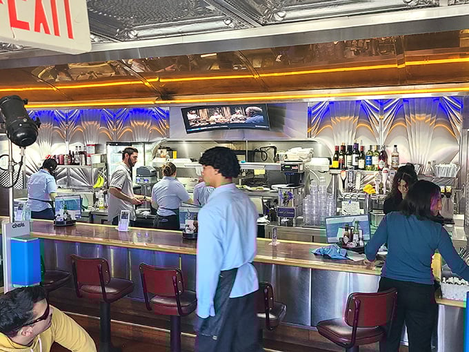Counter seats where you can watch the kitchen magic happen while feeling like a 1950s regular.